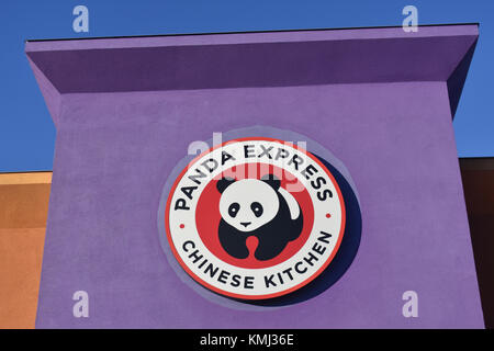 A logo sign outside of a Panda Express fast food restaurant location in ...