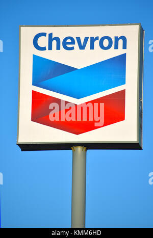 A gas station with a Chevron sign on the side. The building is old and ...