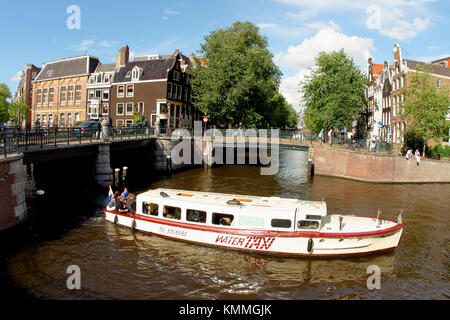 Netherlands Amsterdam water taxi on Herengracht's canal in automn Stock ...
