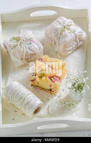 Sweet and tasty yogurt pie packed in a white paper. Pie with cream and ...