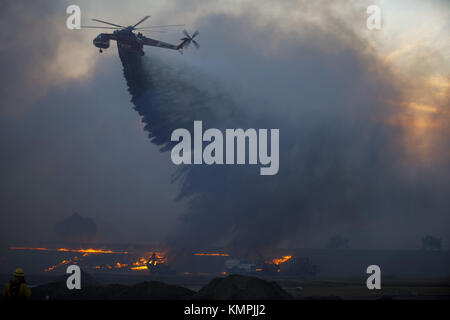 A helicopter drops water to battle wildfires near Concepcion, Chile ...
