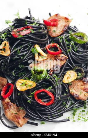 sepia spaghetti with turkey meat and chilli Stock Photo - Alamy