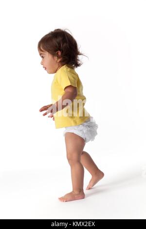 Baby girl walking for the first time on white background Stock Photo ...