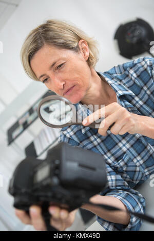 female photographer with magnifying glass Stock Photo - Alamy