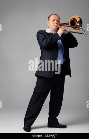 Portrait of young man playing trombone Stock Photo - Alamy