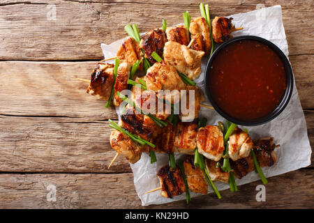 Dakkochi, Korean Chicken on a Stick close-up on the table. vertical ...