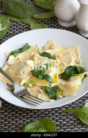 Ricotta and herb ravioli with spinach and pine nuts Stock Photo - Alamy