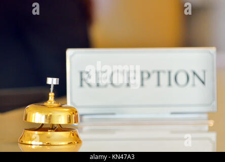young woman and bellhop waiting at hotel reception Stock Photo - Alamy