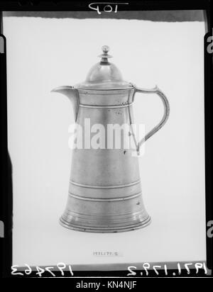 This metal flagon is a traditional vessel designed to hold liquids ...