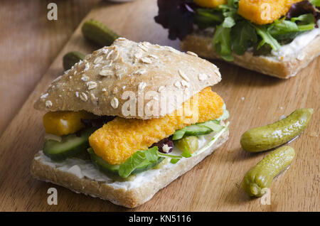 Ciabatta filled with golden fish fingers and salad Stock Photo - Alamy