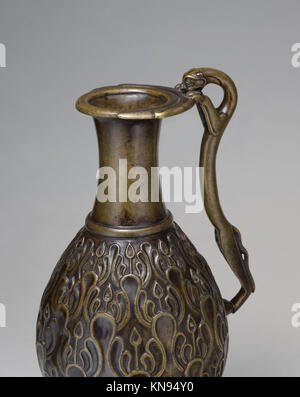 A ceramic ewer with a feline-shaped handle combining utility and ...