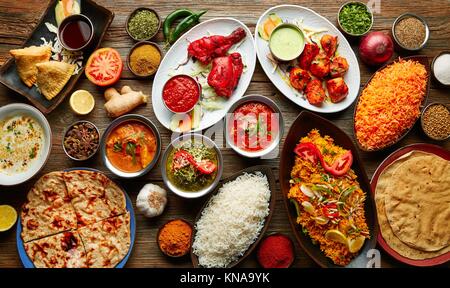 Assorted indian food on a wooden background Stock Photo - Alamy