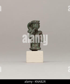 This sculpture depicts a crouching child god holding a scepter ...