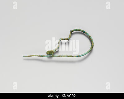 This bronze fibula, designed in the shape of a dragon, is a safety pin ...