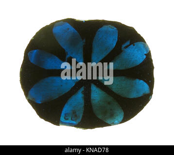 This glass fragment, preserved from an ancient object, showcases the ...