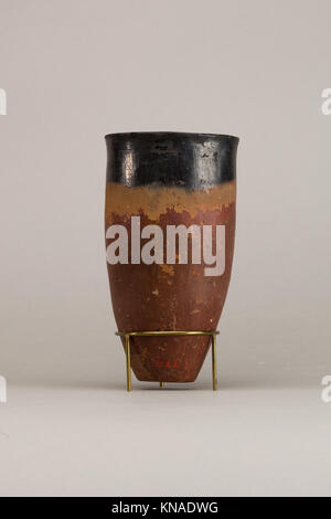 This beaker, crafted from red ware with a distinctive black top ...