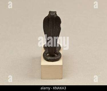 This sculpture of a coiled and rearing cobra captures the dynamic ...