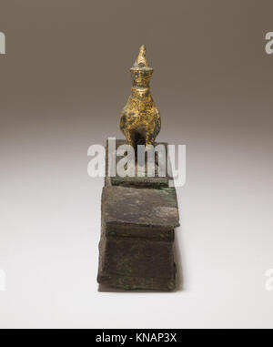 Falcon in double crown surmounting a shrine form box for an animal ...
