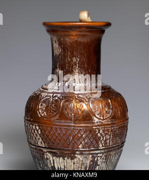 This glass jug demonstrates detailed craftsmanship, combining ...
