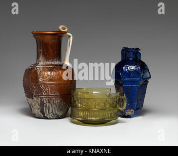 This glass jug demonstrates intricate craftsmanship and design ...