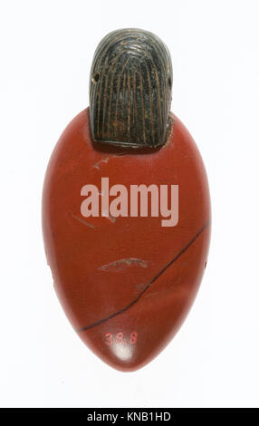 This heart-shaped amulet features a human head, symbolizing protection ...