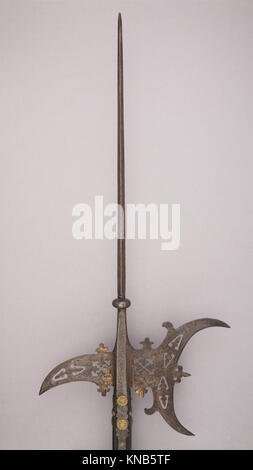 This medieval halberd combines an axe blade and spear tip, exemplifying ...