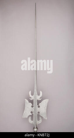 This medieval halberd combines an axe blade and spear tip, exemplifying ...