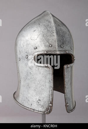 This medieval barbute helmet features an open-faced design with a nasal ...
