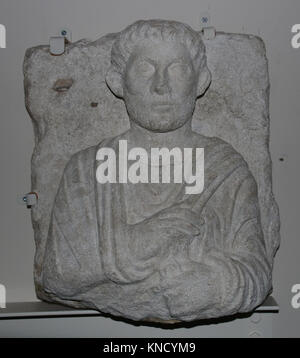 This funerary relief depicts a scene from ancient burial practices. It ...