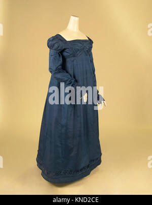 This dress exemplifies the fashion of its time, with details reflecting ...