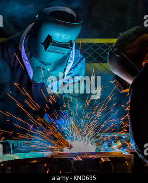 Welders team welding automotive part in assembly line Stock Photo - Alamy