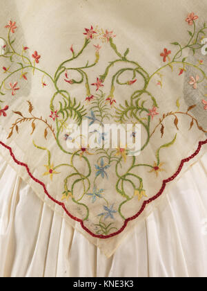 A historical 18th-century fichu worn around the neck, highlighting ...