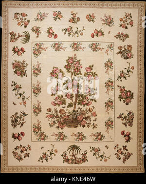 A vibrant quilt featuring an intricate pattern of colorful geometric ...