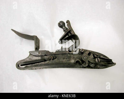 This flintlock gun is an early firearm from the 17th century, featuring ...