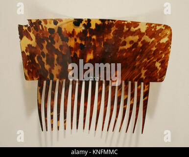 This comb, made of fine materials, showcases intricate design and ...