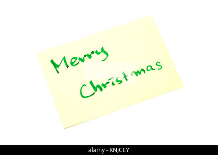Merry christmas writen on yellow sheet and christmas ball on white ...