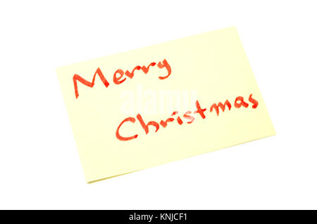 Merry christmas writen on yellow sheet and christmas ball on white ...