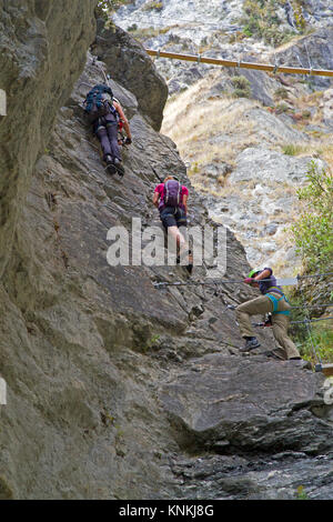 Climbers on the Wildwire via ferrata route at Twin Falls in Wanaka ...
