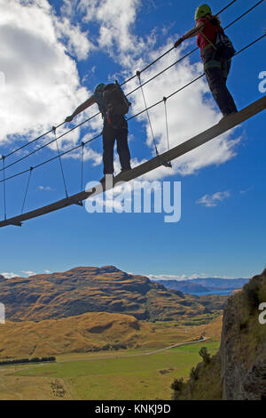 Climbers on the Wildwire via ferrata route at Twin Falls in Wanaka ...