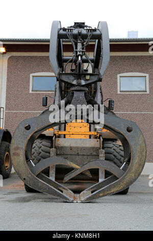 front loader for loading timber. an industrial tractor transports ...