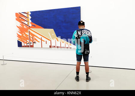 Visitors looking at Ed Ruscha painting Norm's La Cienega on Fire in a ...