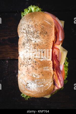 Sandwich with ciabatta bread and bacon from above in the plate ...