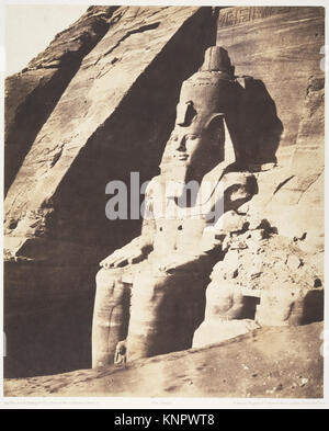 Three-quarter view of the colossal statues at Abou Simbel ...