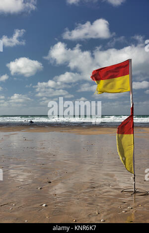 Red and yellow flags on patrolled beach indicating safe to swim area ...