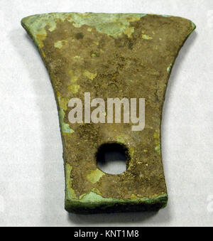 This metal axe head displays blade structure and haft fitting ...