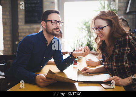 Flirting coworkers eating out and dating in restaurant Stock Photo - Alamy