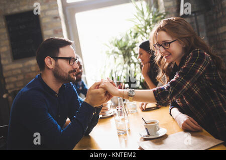 Flirting coworkers eating out and dating in restaurant Stock Photo - Alamy