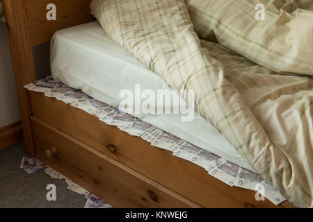 A ready supply of stashed cash money banknotes under the bed mattress ...