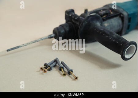 Drilling machine and dowels on gypsum board Stock Photo - Alamy