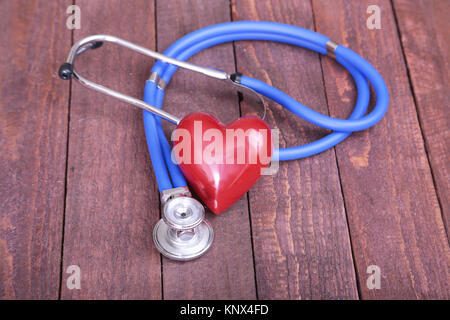 Red stethoscope on wooden background Stock Photo - Alamy